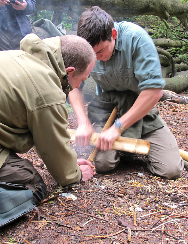 Keith assists Dan Hume in the Bamboo Fire Saw method of friction fire ...